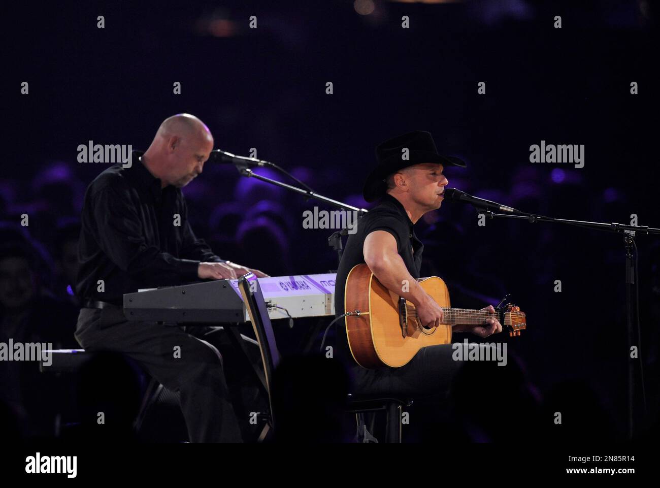 Kenny Chesney, right, performs "One Step Up" at the MusiCares Person of ...