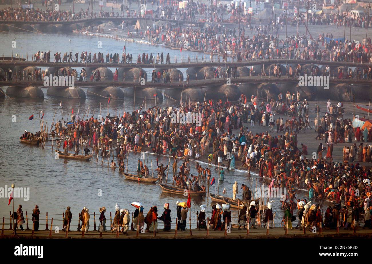 Indian devotees arrive for a holy dip at Sangam, the confluence of the ...