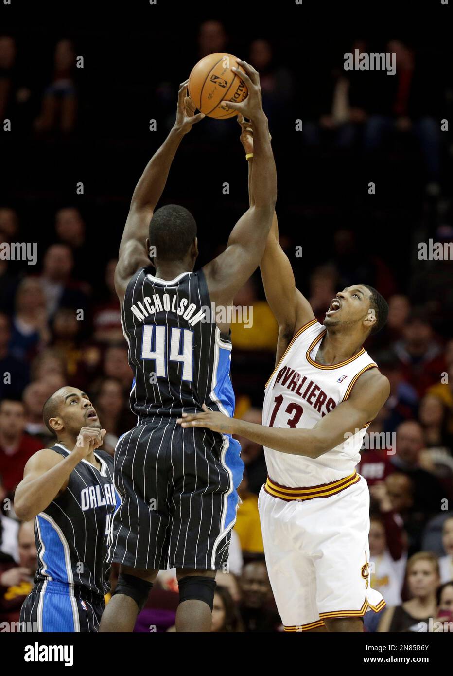 Cleveland Cavaliers' Tristan Thompson (13) defends a shot by Orlando ...