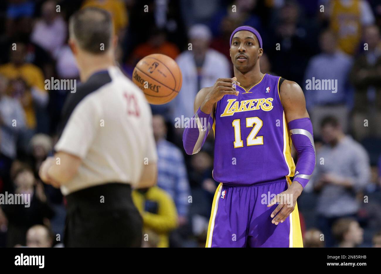 Los Angeles Lakers' Dwight Howard (12) tosses the ball to a referee ...