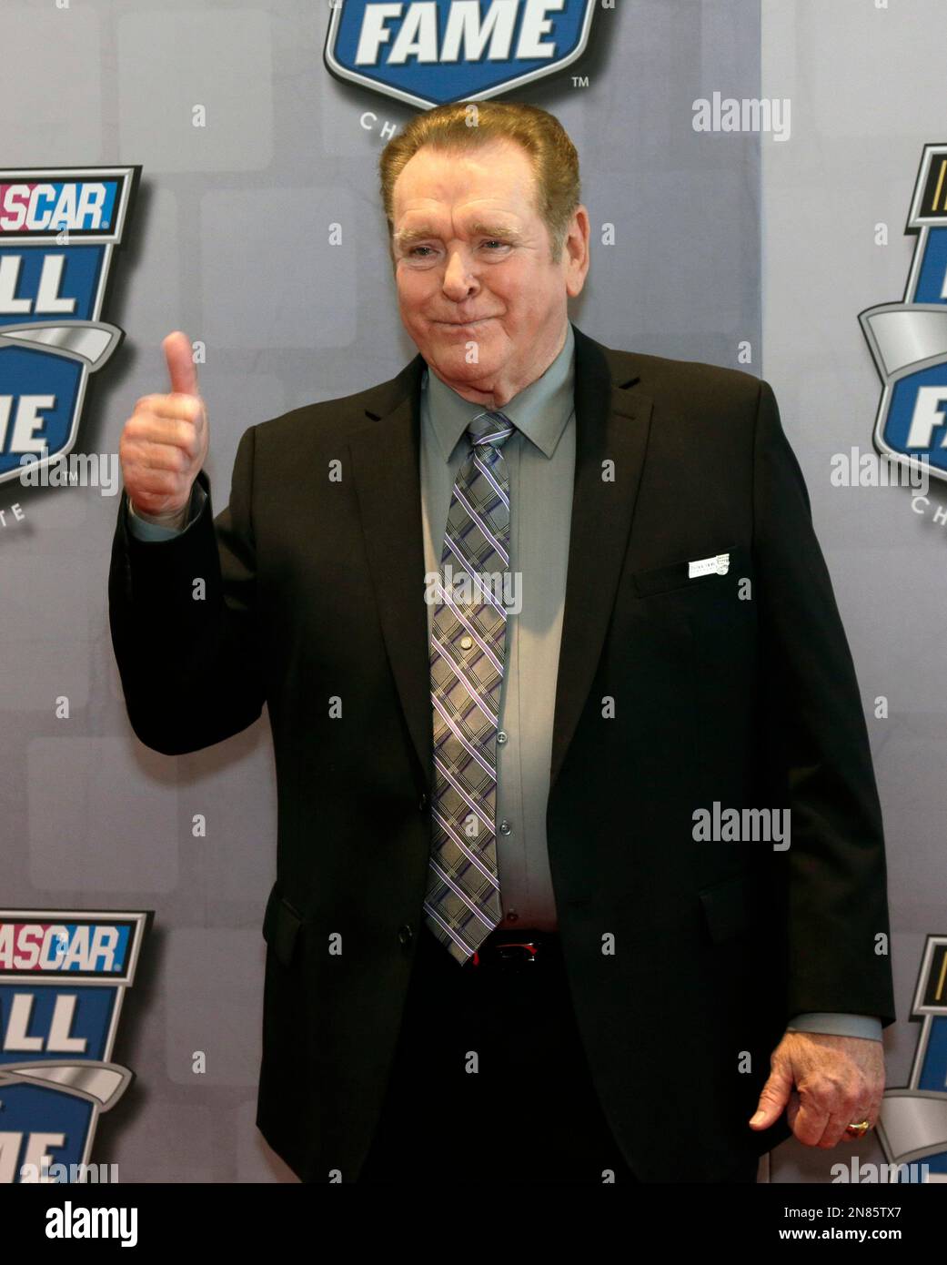 Former NASCAR driver Buddy Baker flashes a thumbs-up to the media as he ...