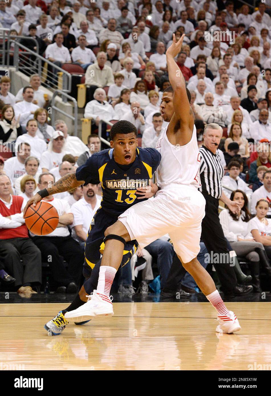Marquette's Vander Blue, left, attempts to drive around the defense of ...