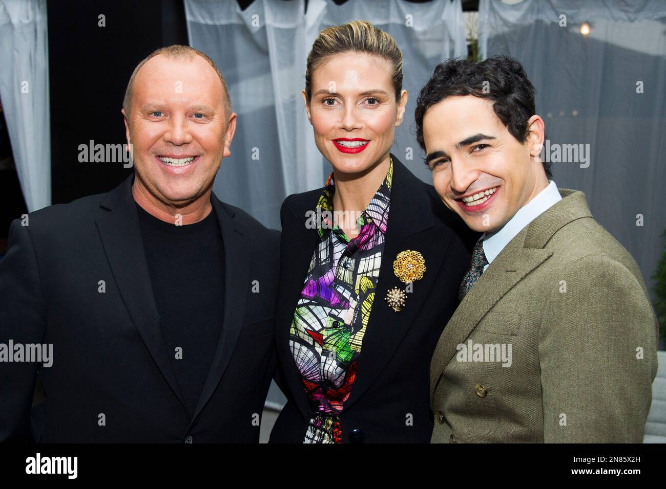 Michael Kors, from left, Heidi Klum and Zac Posen pose before the Fall ...