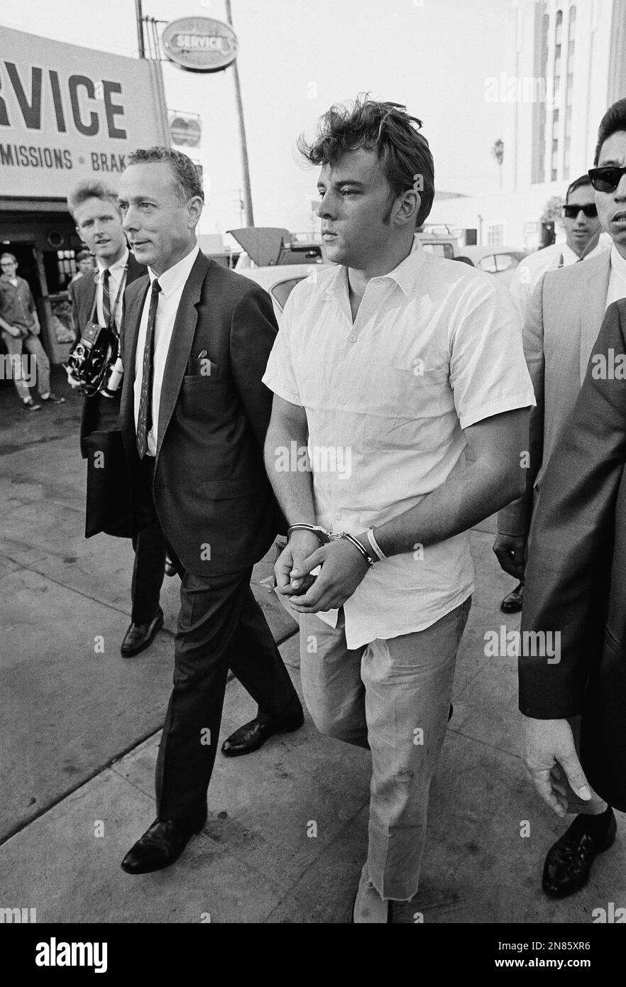 Paul Robert Ferguson, 22, in handcuffs, is escorted by police from jail ...