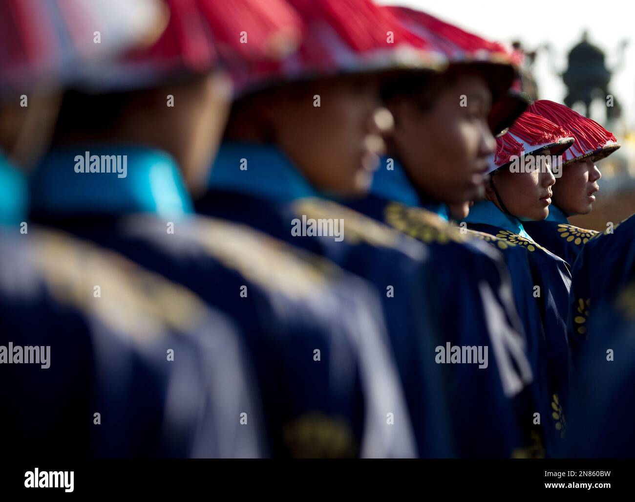 Chinese actors dressed as Qing Dynasty servants listen to an officer ...