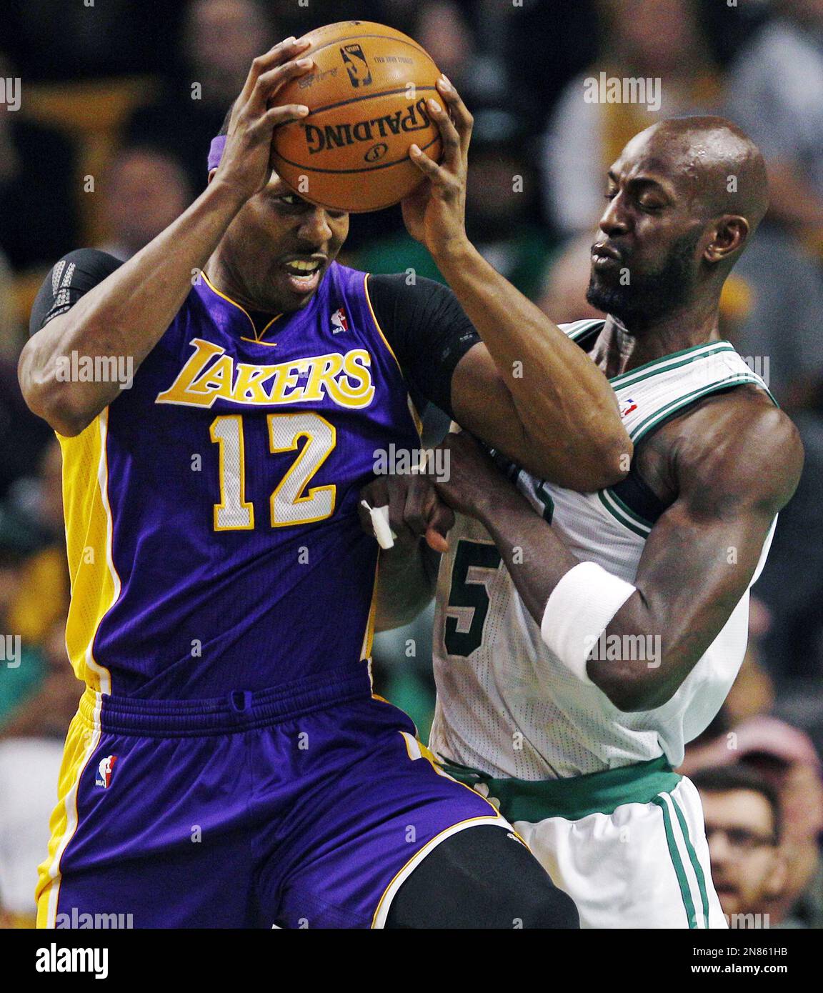 Los Angeles Lakers center Dwight Howard (12) tries to break free from ...