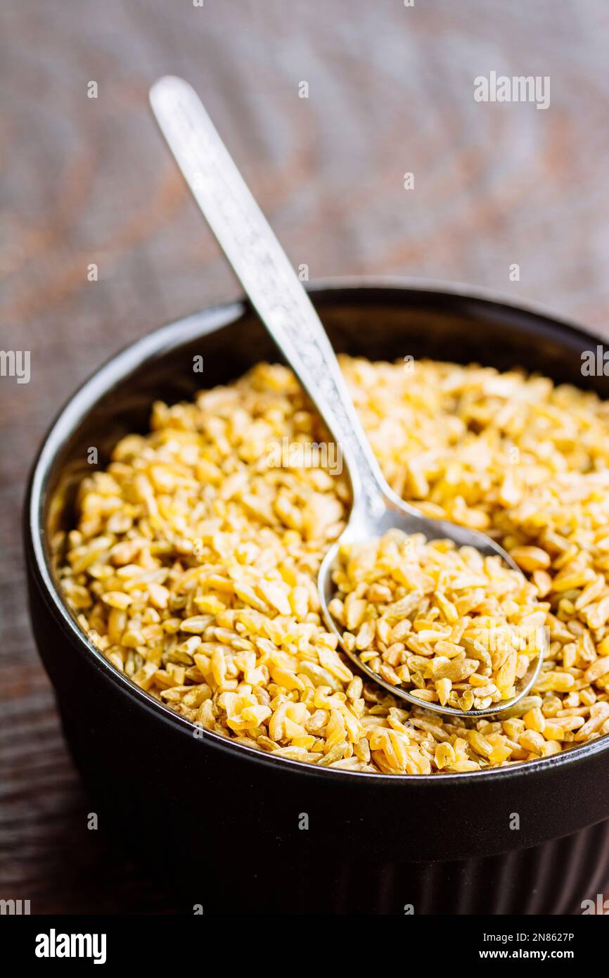 Freekeh in a bowl. Freekeh is a cereal made from green wheat Stock ...