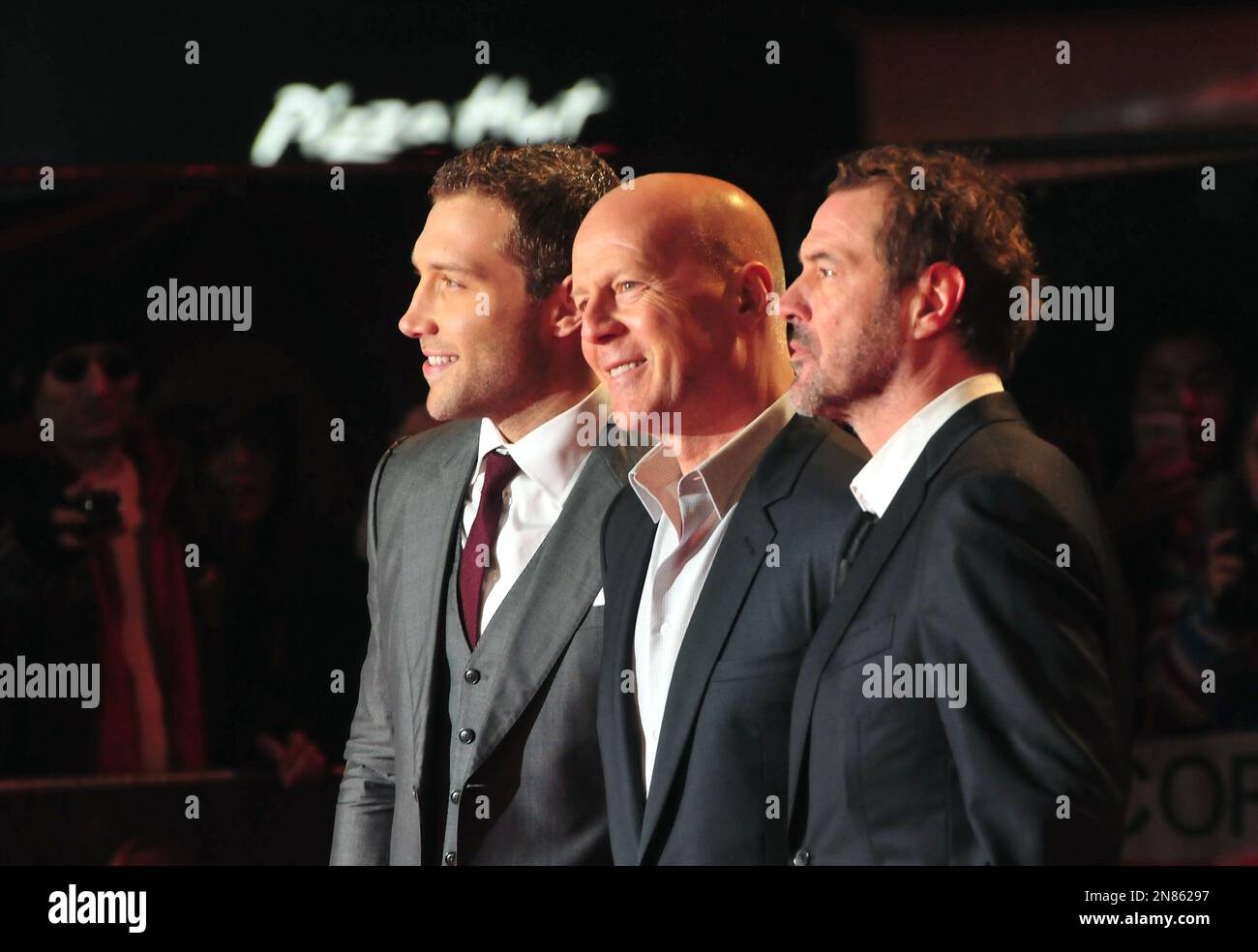 From left, Jai Courtney, Bruce Willis, and Sebastian Koch arrive at the ...
