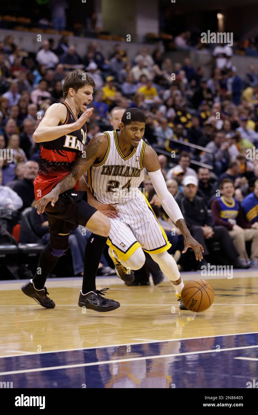 Indiana Pacers forward Paul George, right, drives on Atlanta Hawks ...