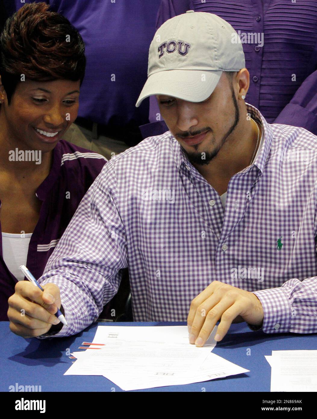 Nikki Luper watches her son, Cameron Echols-Luper, signs a letter of ...