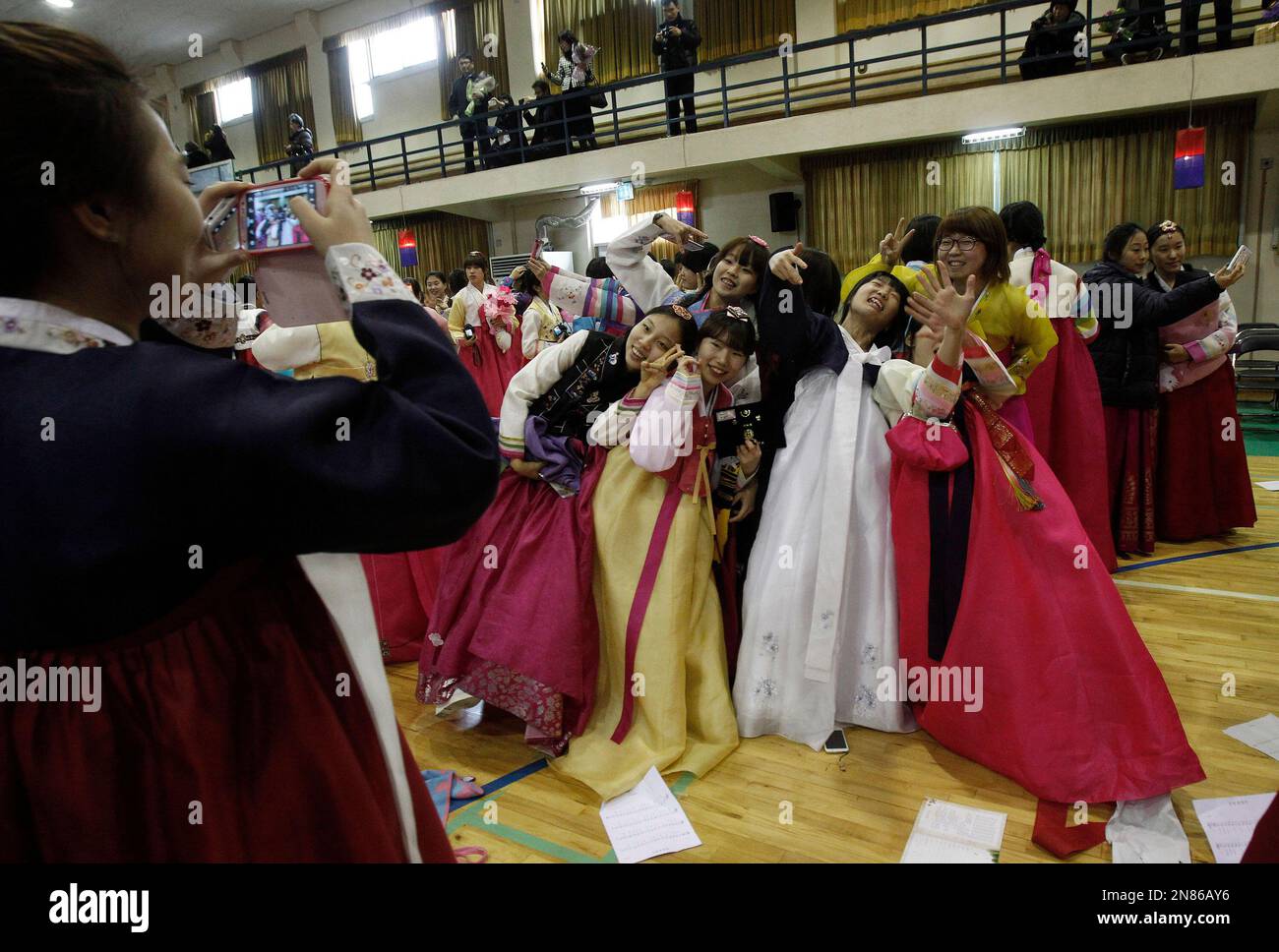 South Korean senior students clad in traditional costumes pose for a ...
