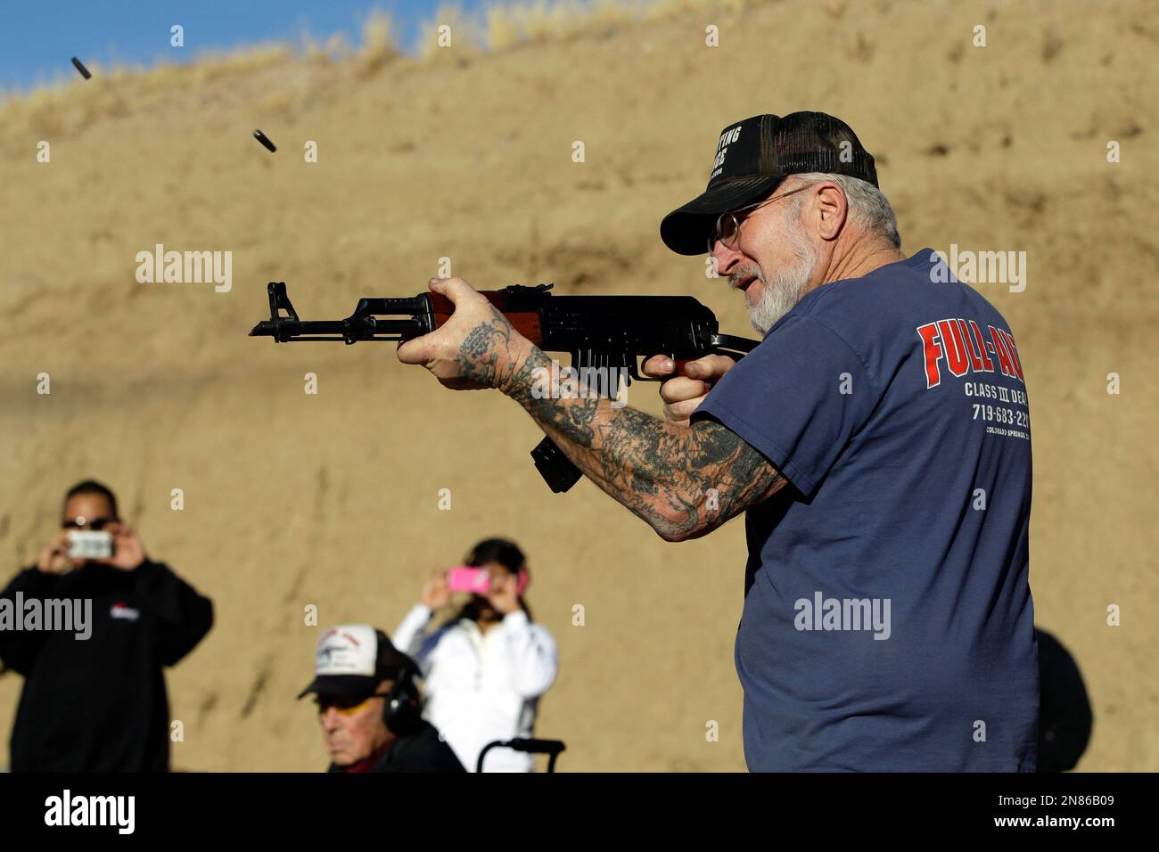 Gun dealer Mel Bernstein fires his AK-47 assault rifle on full ...
