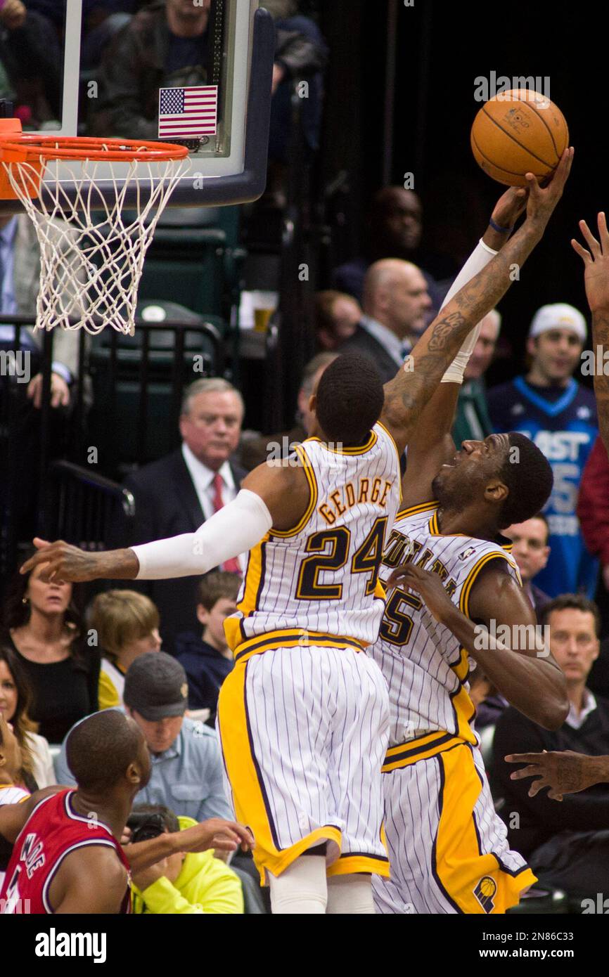 Indiana Pacers' Paul George (24) and Roy Hibbert (55) go for a rebound ...