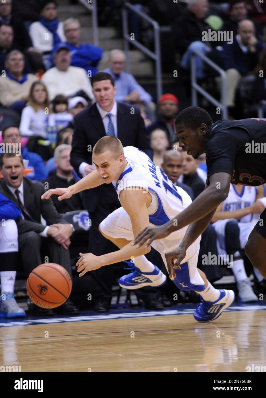Seton Hall's Haralds Karlis, left, and Cincinnati's Cheikh Mbodj go ...