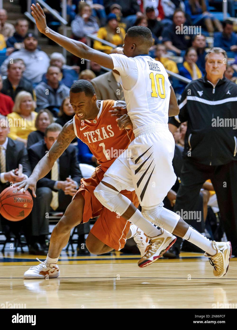 Texas' Sheldon McClellan (1) is fouled by West Virginia's Eron Harris ...