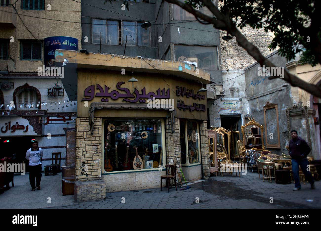 In this Thursday, Jan. 3, 2013 photo, A man, right, walks past an ...
