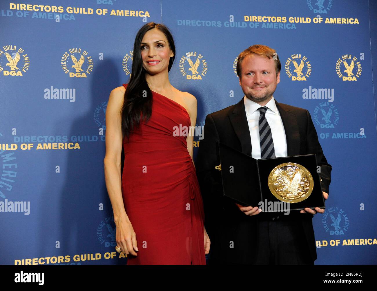 Famke Janssen, left, poses with Rian Johnson and his award for ...