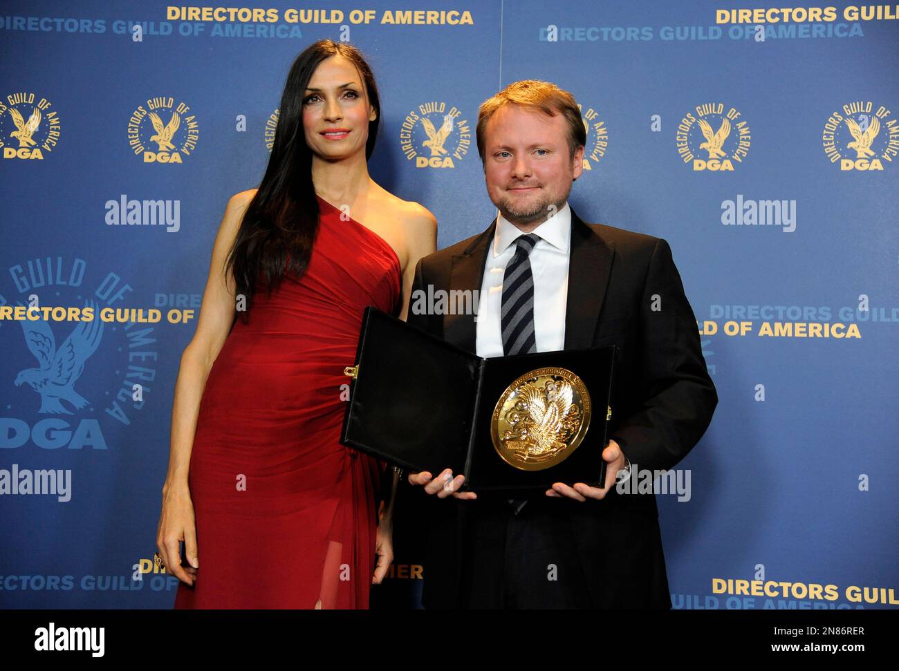 Famke Janssen, left, poses with Rian Johnson and his award for ...