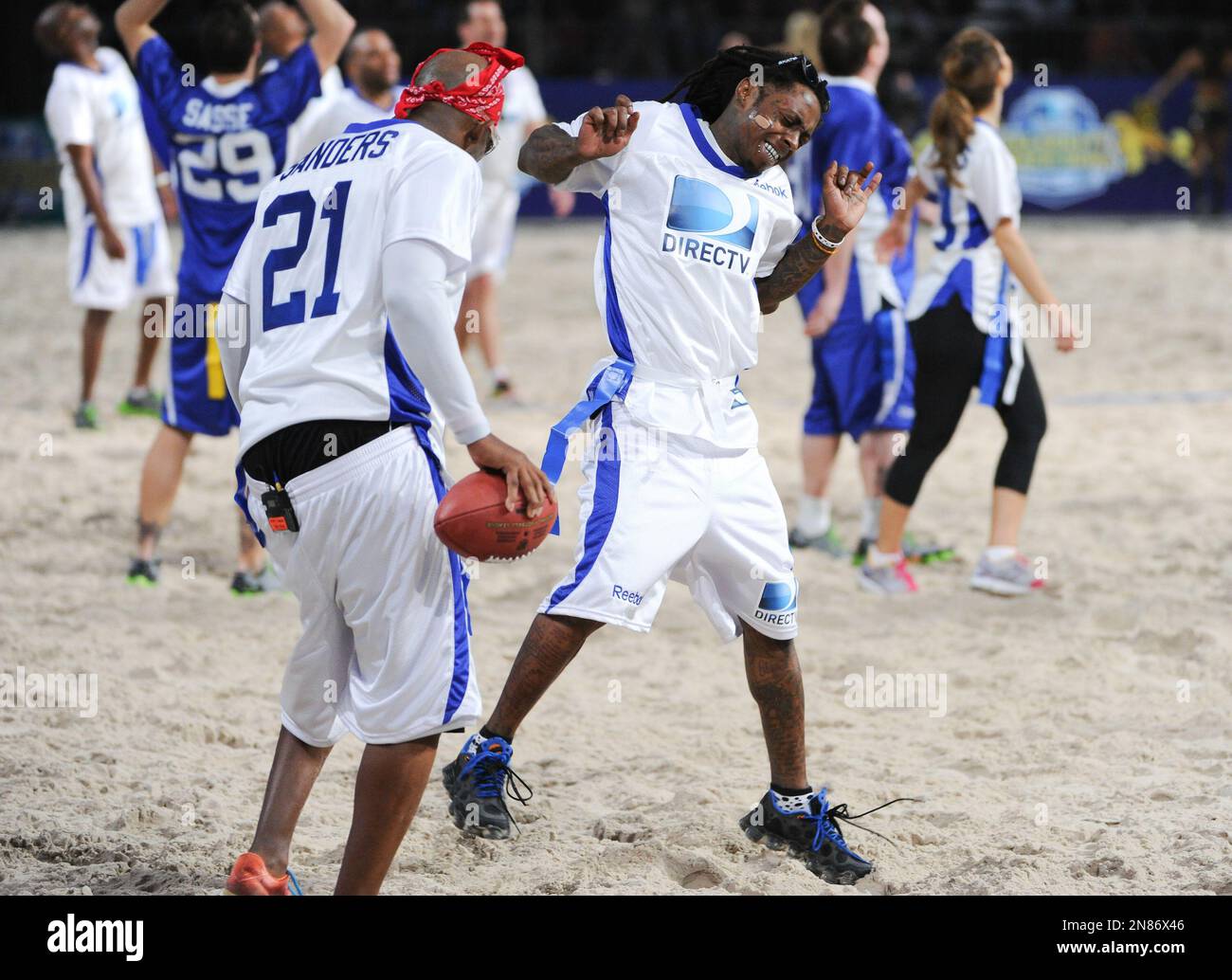 Rapper Lil Wayne celebrates with former NFL player Deion Sanders during ...
