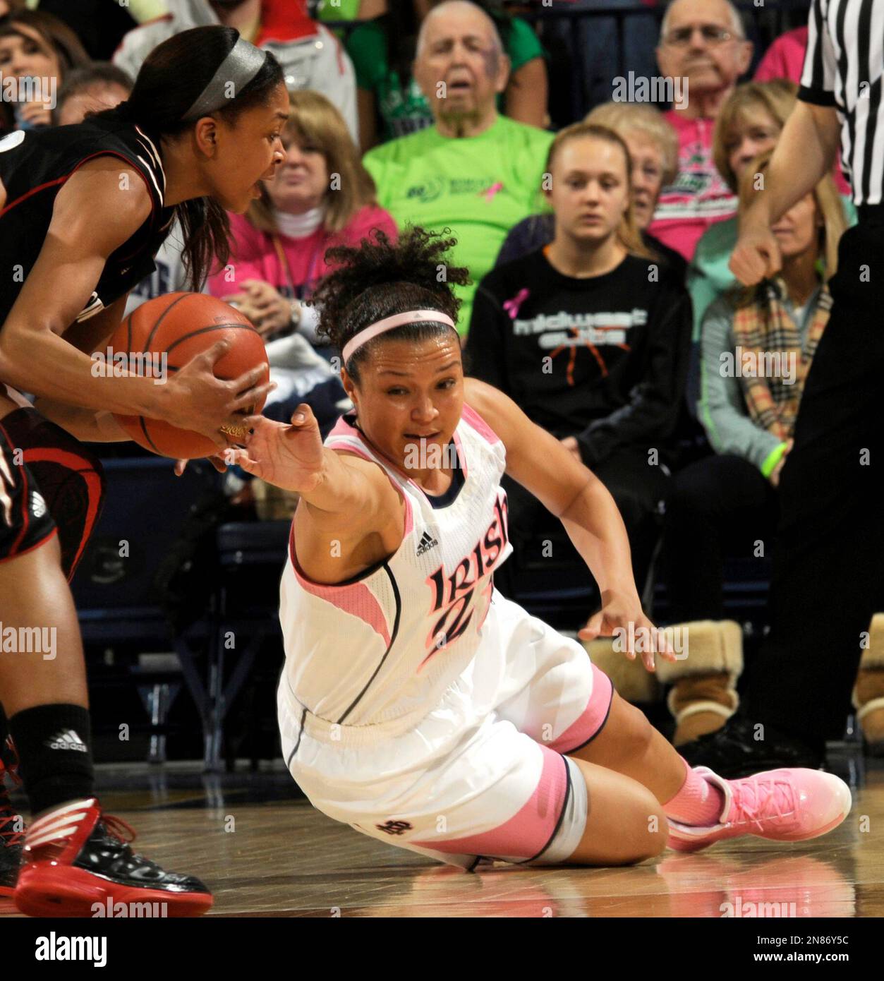 Notre Dame guard Kayla McBride, right, tries to knock the ball away ...