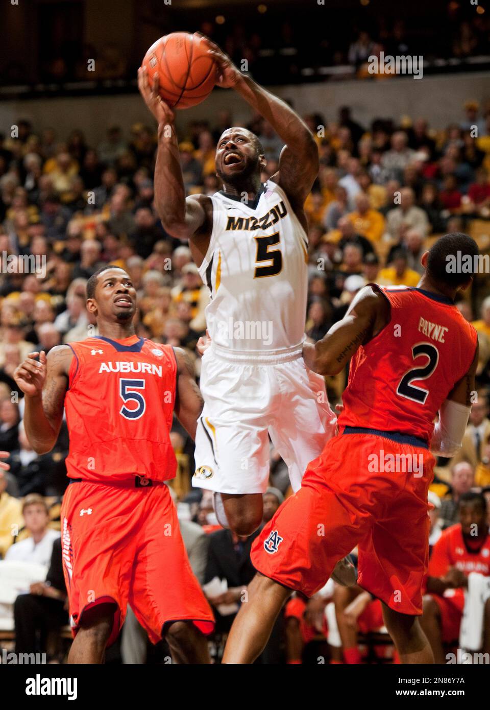 Missouri's Keion Bell, center, is fouled as he shoots between Auburn's ...
