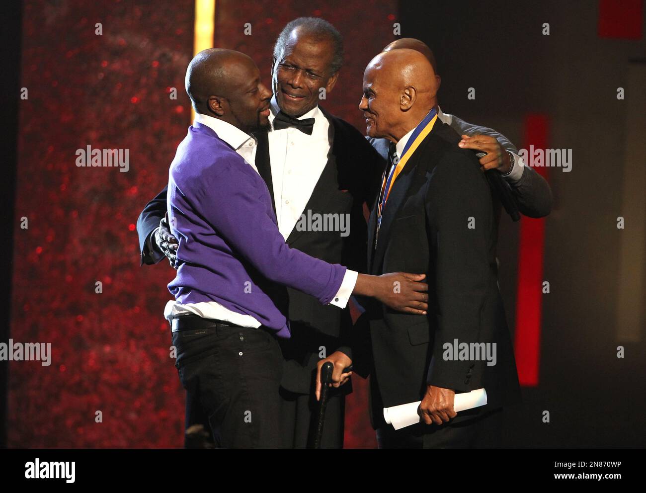 From left, Wyclef Jean and Sidney Poitier present the Spingarn award to ...