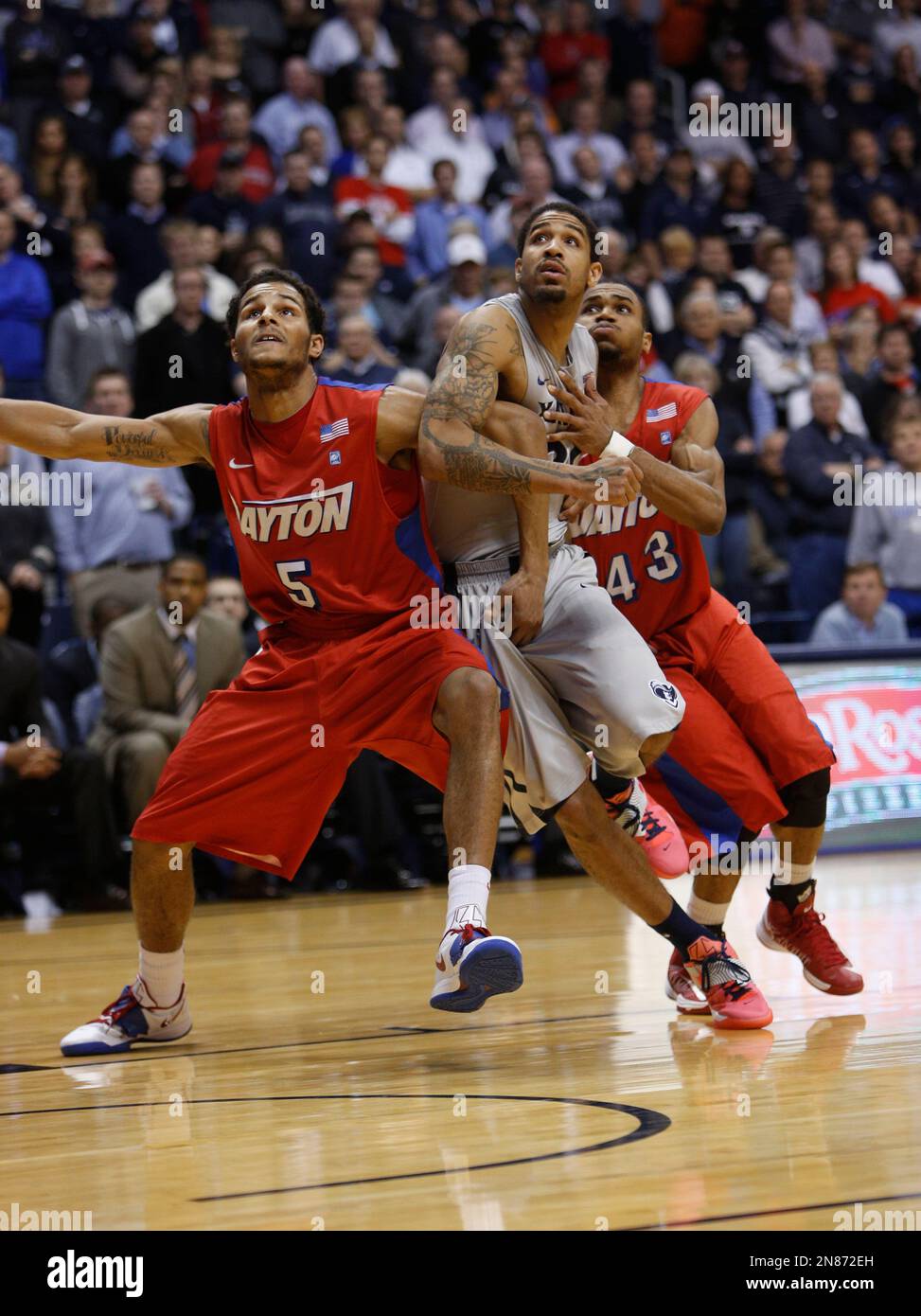 Dayton forward Devin Oliver, left, Xavier forward Justin Martin, middle ...