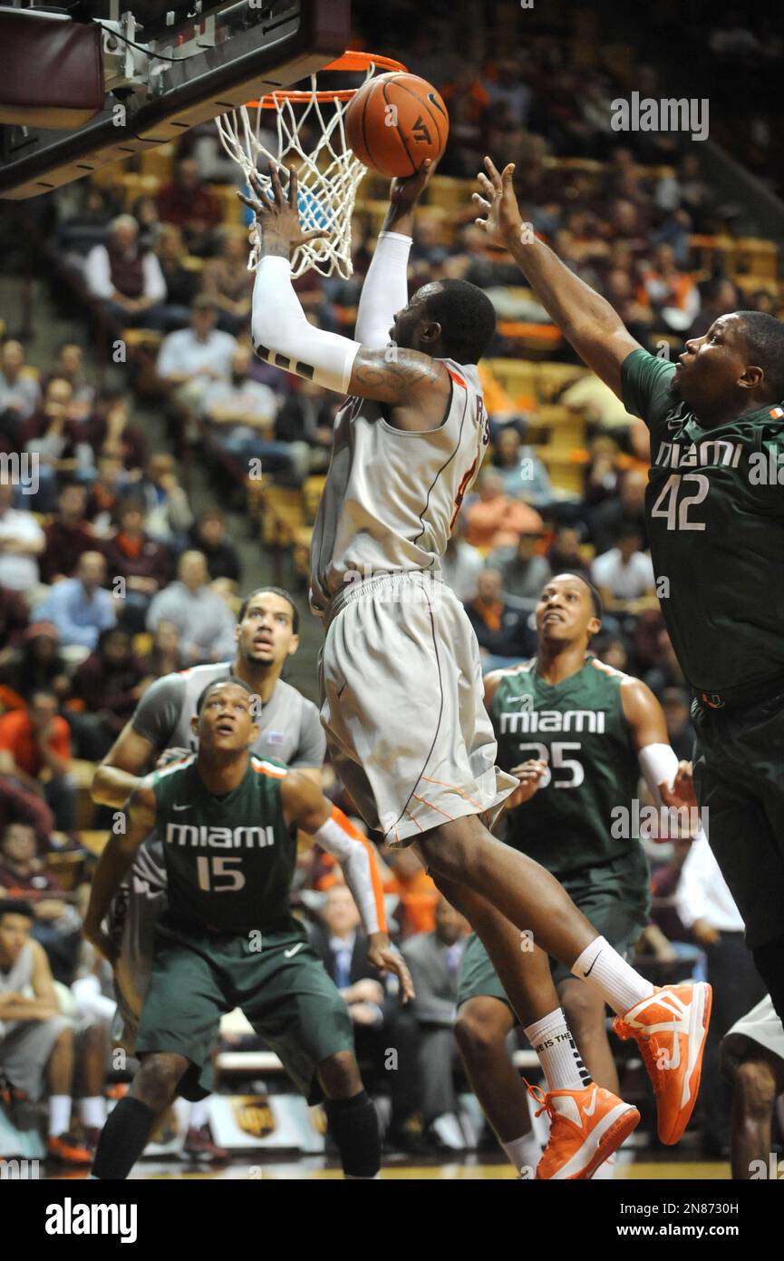 Miami's Reggie Johnson (42) tries to block a shot by Virginia Tech's ...