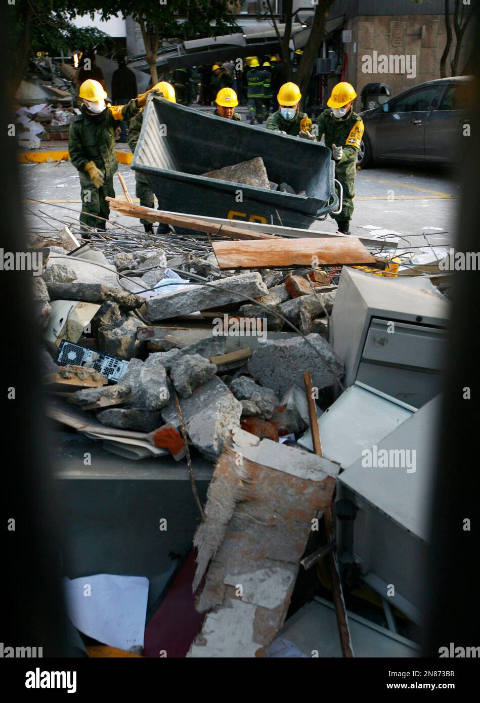 Soldiers remove debris after an explosion at the state-owned oil ...