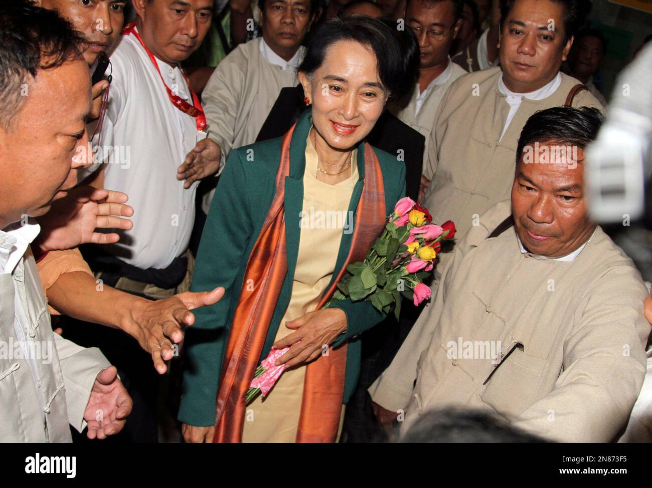 Myanmar opposition leader Aung San Suu Kyi, centre, arrives at Yangon international airport as ...
