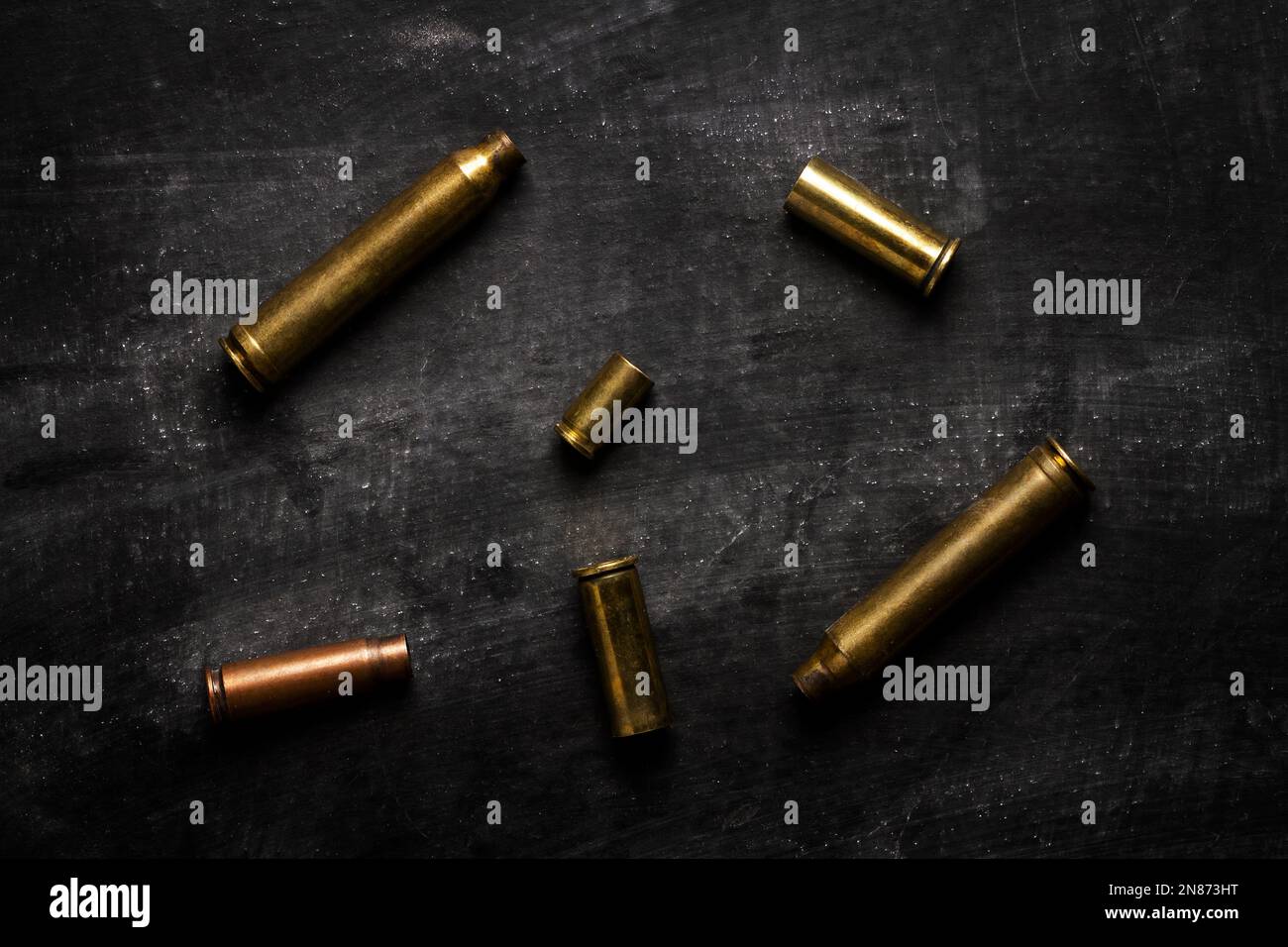 Empty bullet cartridges lying on the black background Stock Photo - Alamy