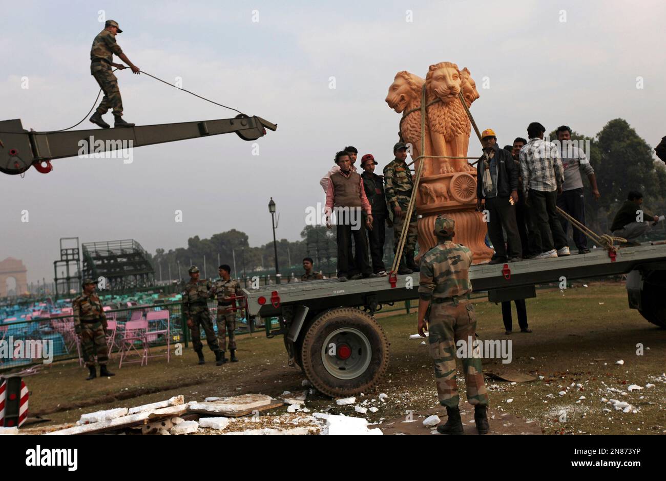 Indian army soldiers and municipal workers load a stone sculpture of ...