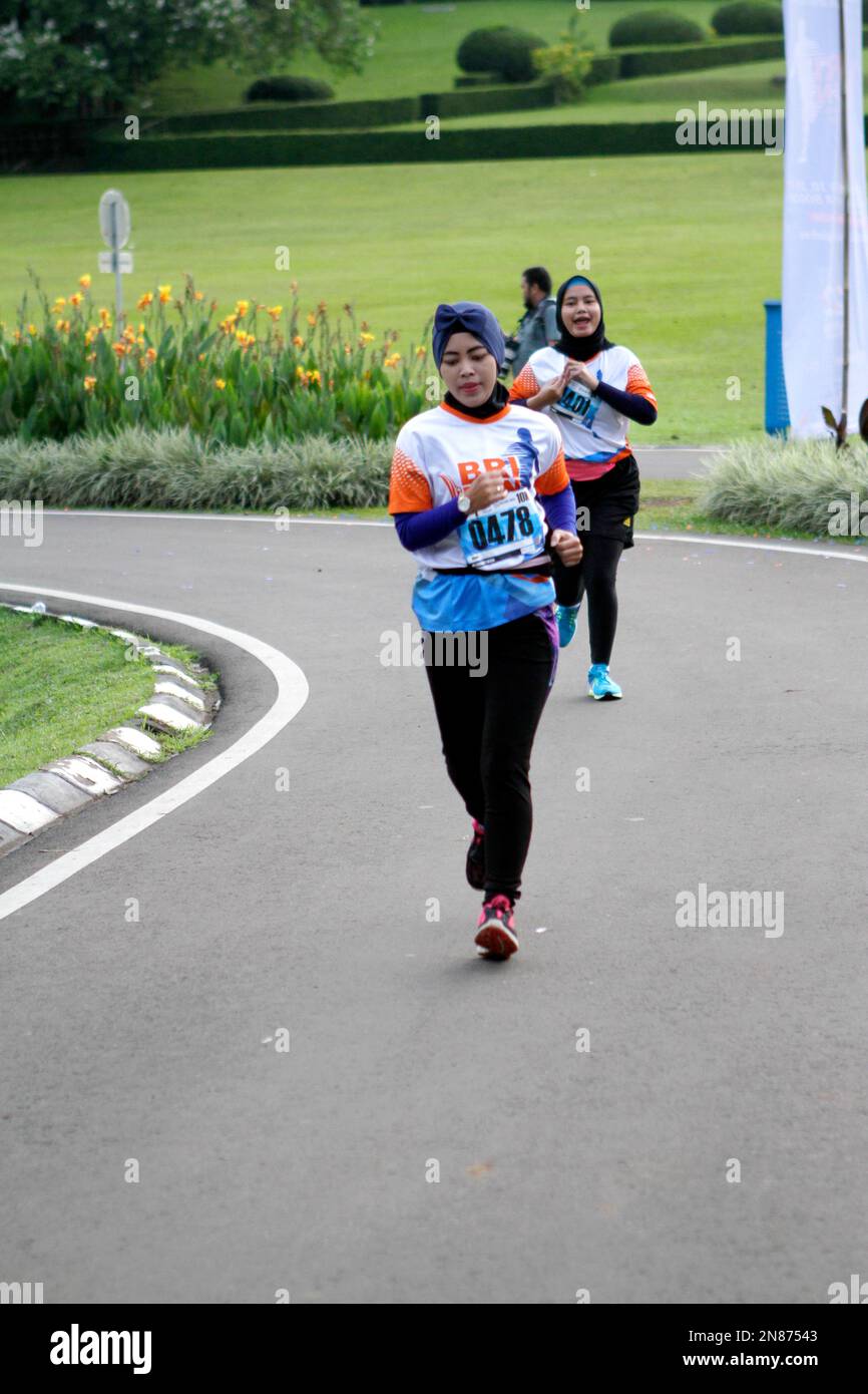 a marathon running event which is attended by many participants, both ...