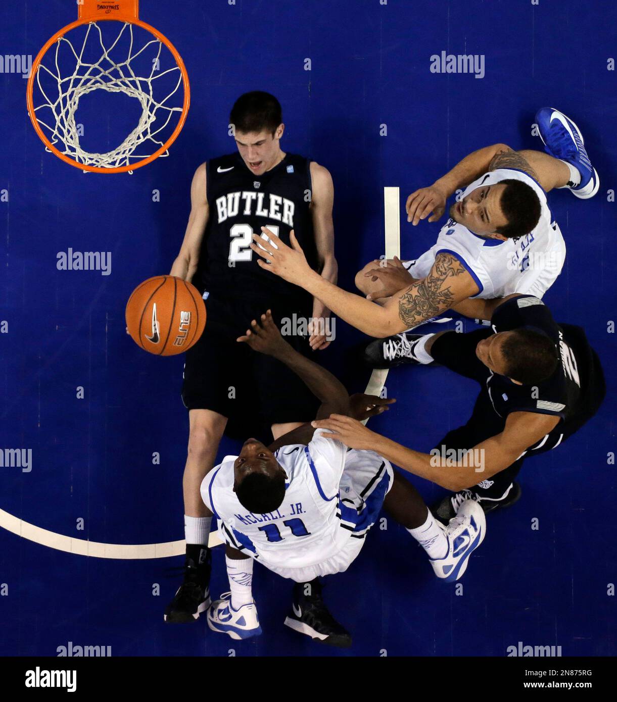 Saint Louis' Mike McCall Jr., bottom left, shoots as Butler's Kellen ...