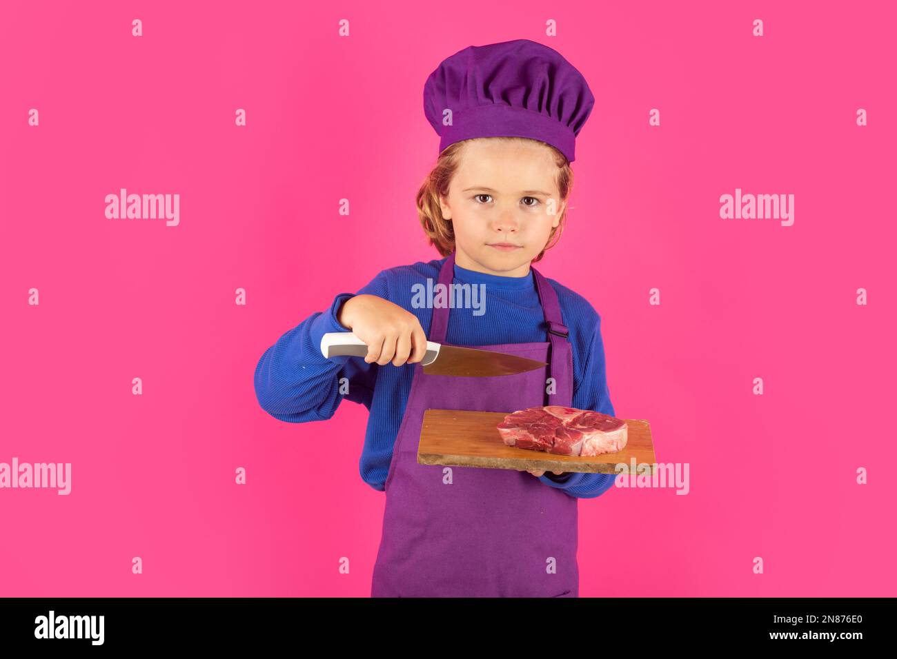 Child cook hold cutting board with meat beef steak and knife. Cooking ...