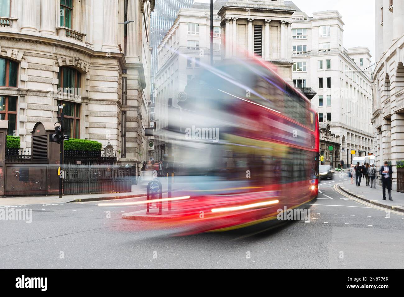 picture of a city street scene in London UK with a London bus in motion ...