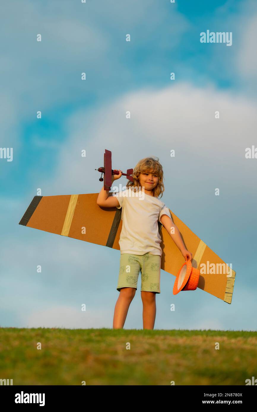 Dream of flying. Little children with toy airplane in a field at sunset ...