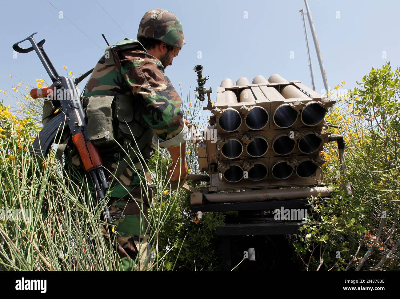 FILE - In this May 22, 2010 file photo, a Hezbollah fighter, stands ...