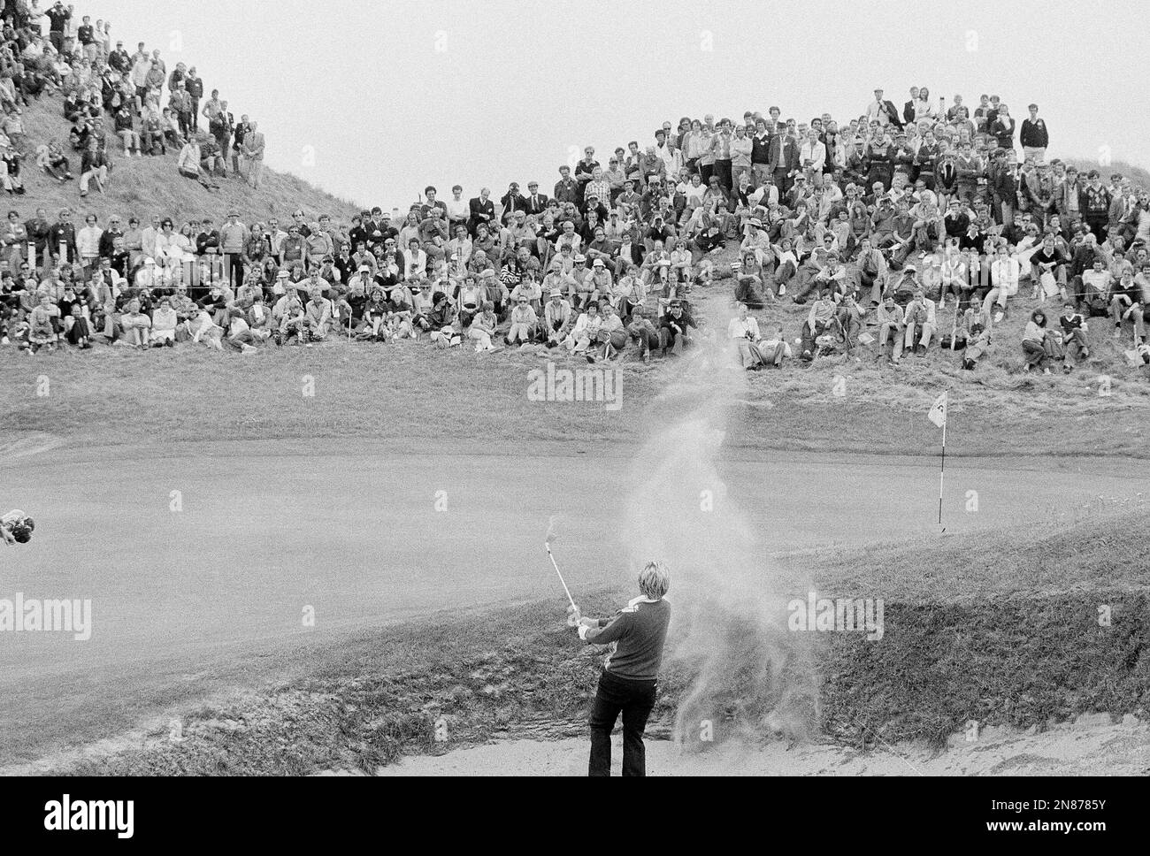 Pro golfer Jack Nicklaus hits out of a bunker at the 6th hole towards a ...