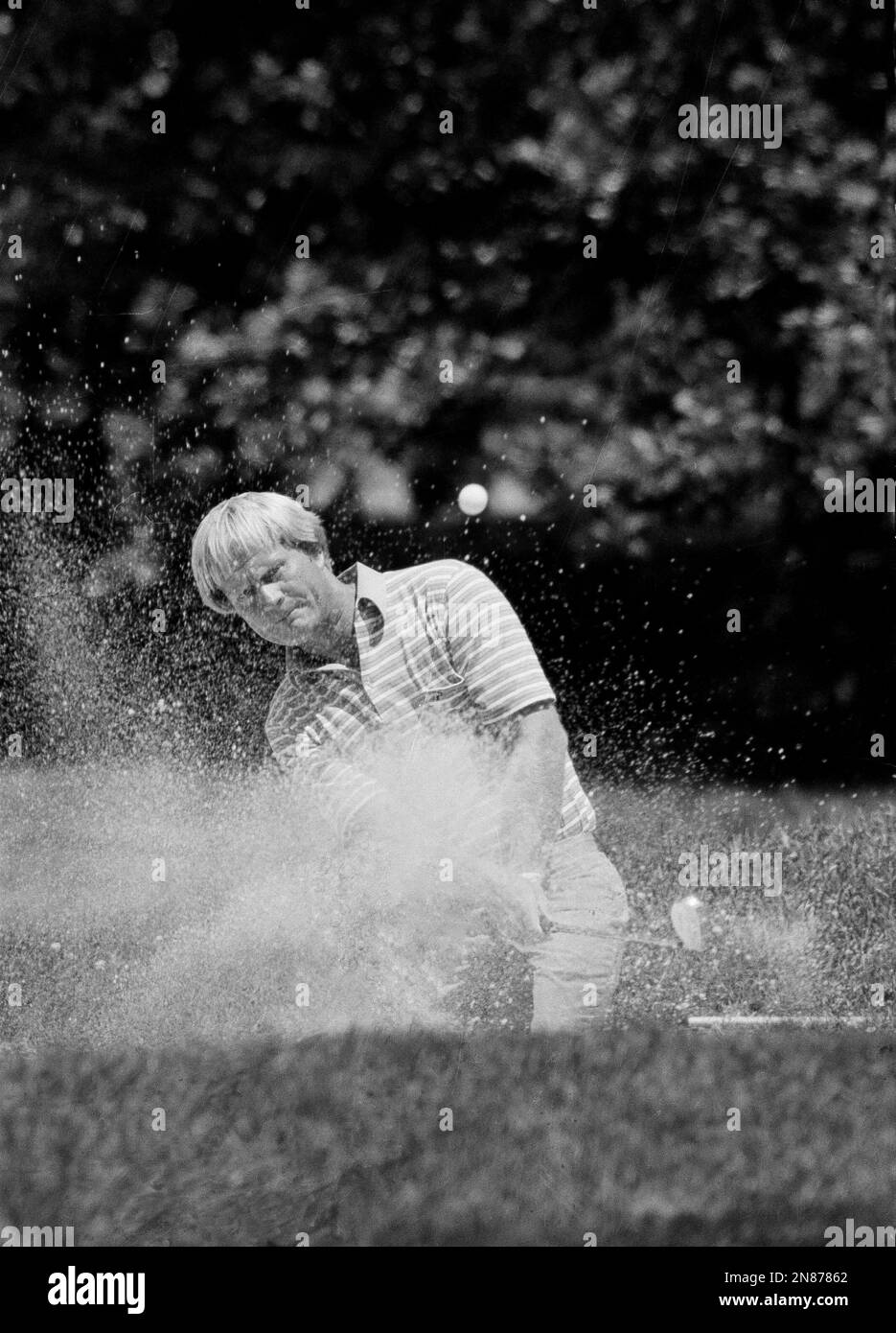 Pro golfer Jack Nicklaus blasts from the trap to the first green for a ...
