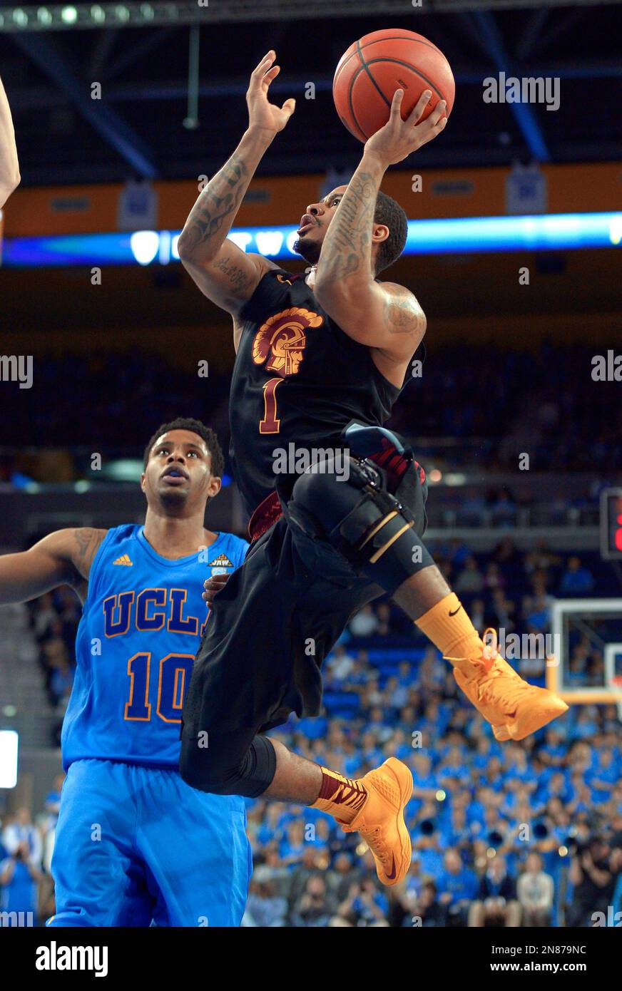 Southern California guard Jio Fontan, right, puts up a shot as UCLA ...