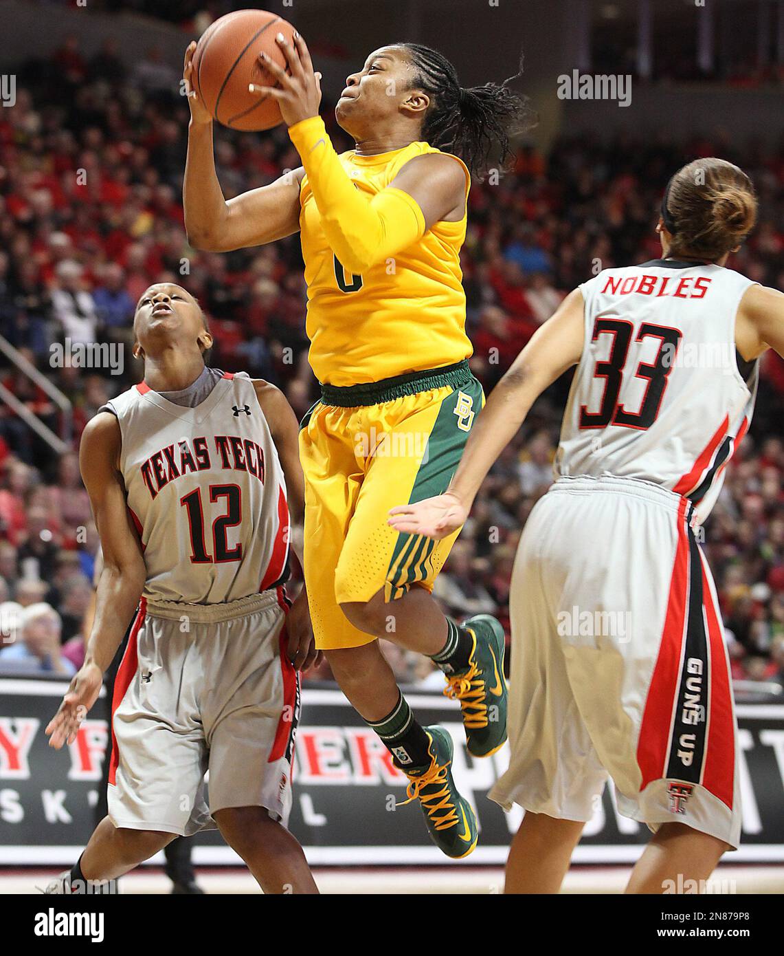 Baylor's Odyssey Sims drives between Texas Tech's Amber Battle(12) and ...
