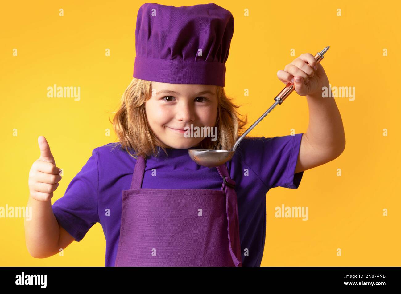 Funny kid chef cook with kitchen ladle, studio portrait. Excited chef ...