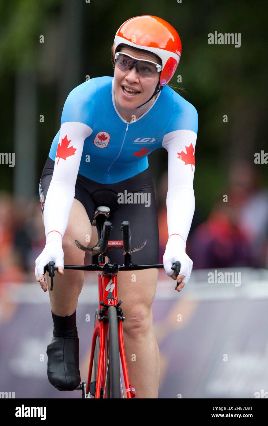 Clara Hughes of Canada smiles as she crosses the finish line in the ...