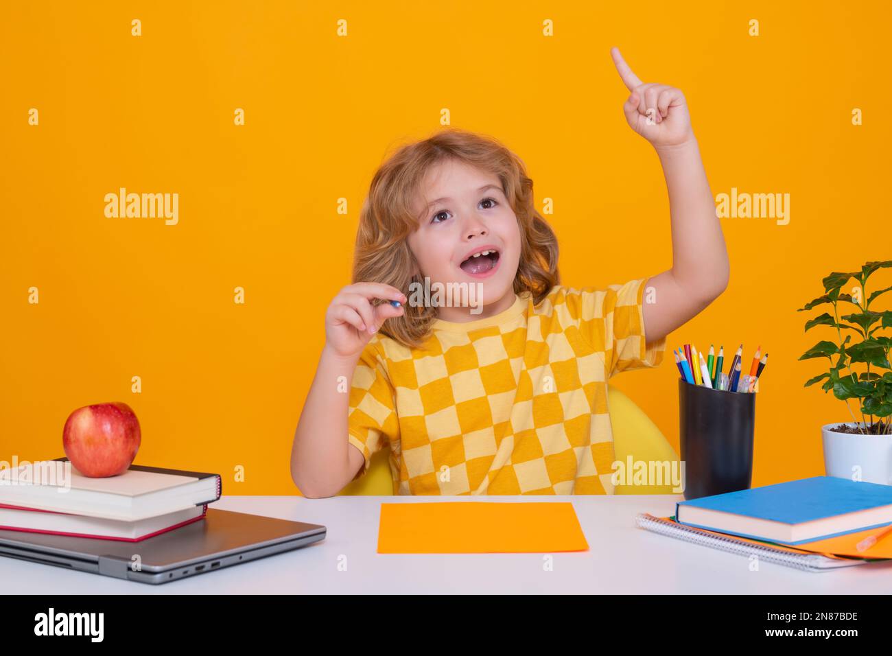 Excited pupil. School kid holding index finger up with great new idea ...