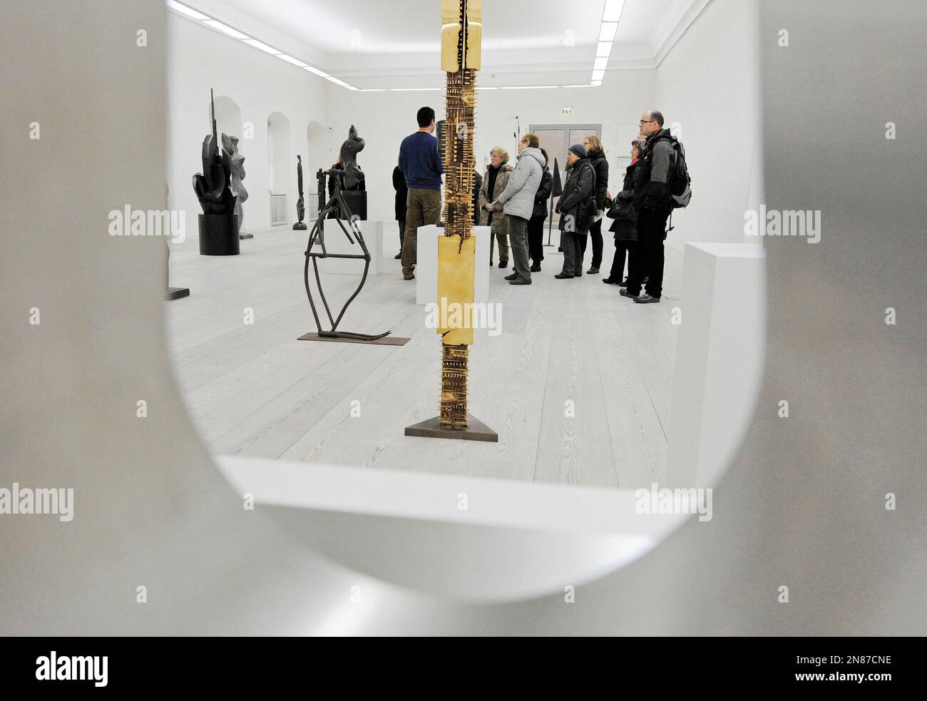 Vistors walk between sculptures during a preview of the exhibition ...