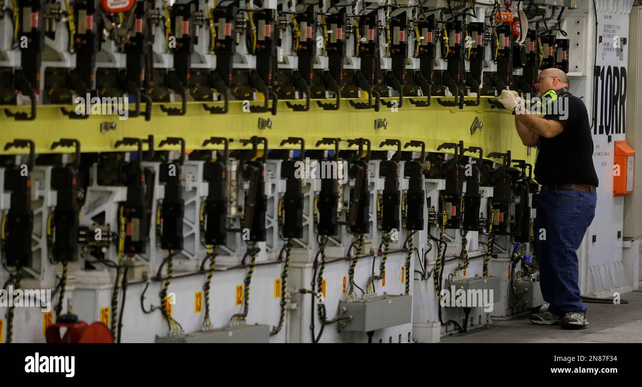 Boeing Co. worker Martin Deslauriers attaches clamps to a wing spar of ...