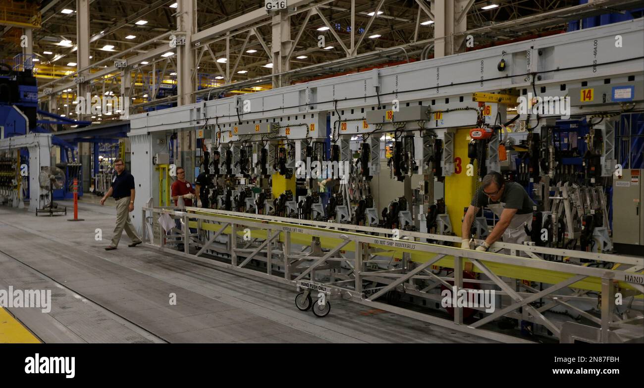 Boeing Co. workers prepare to lift a piece of a wing spar into place on ...