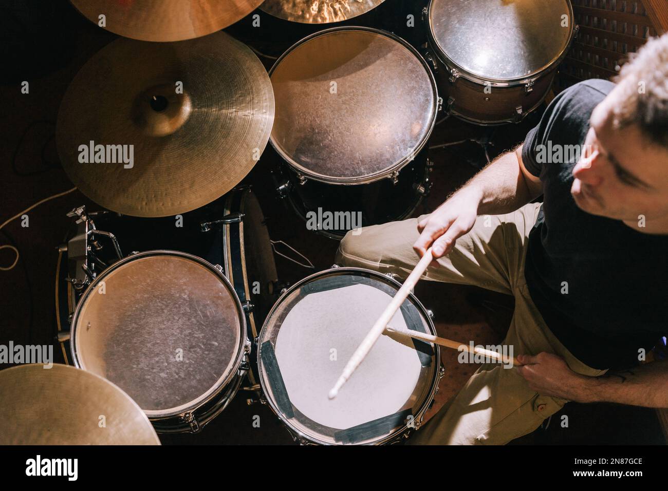 Drummer playing on drum set top view Stock Photo - Alamy