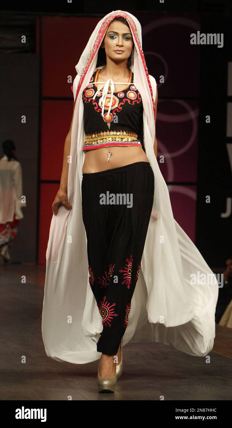 A Pakistani model presents a creation of designer duo, Faisal and ...